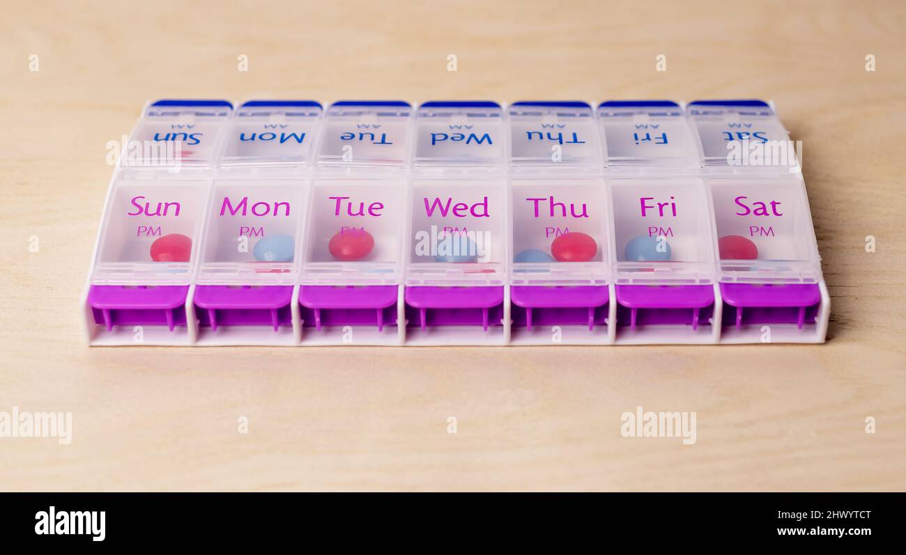 Weekly pills case. Plastic, portable organizer with tablets and ...