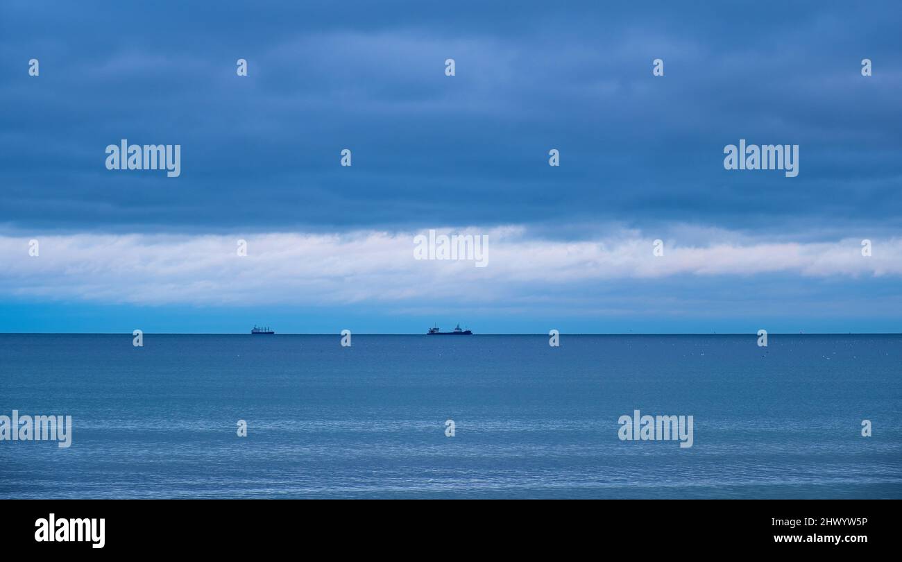 Panoramic winter view of Baltic sea with gulls on water and ships over ...