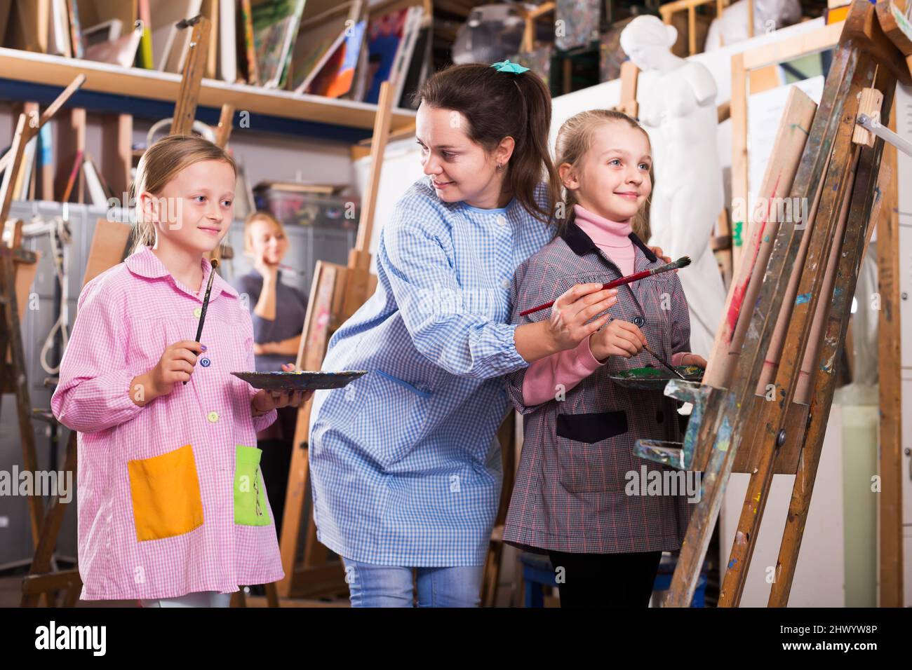 Teacher working at painting class Stock Photo - Alamy
