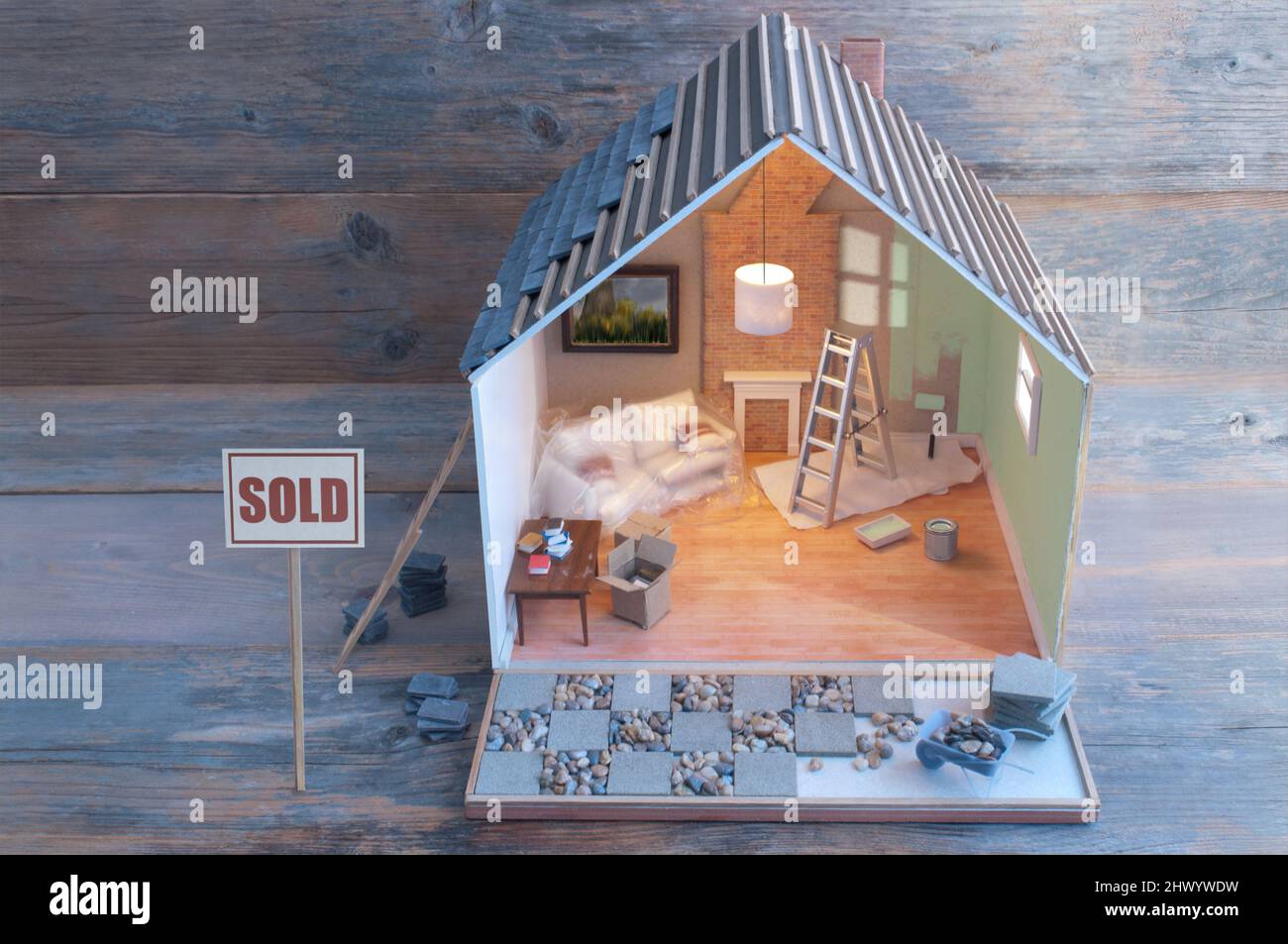 Miniature house with sold sign and diy renovation underway Stock Photo ...