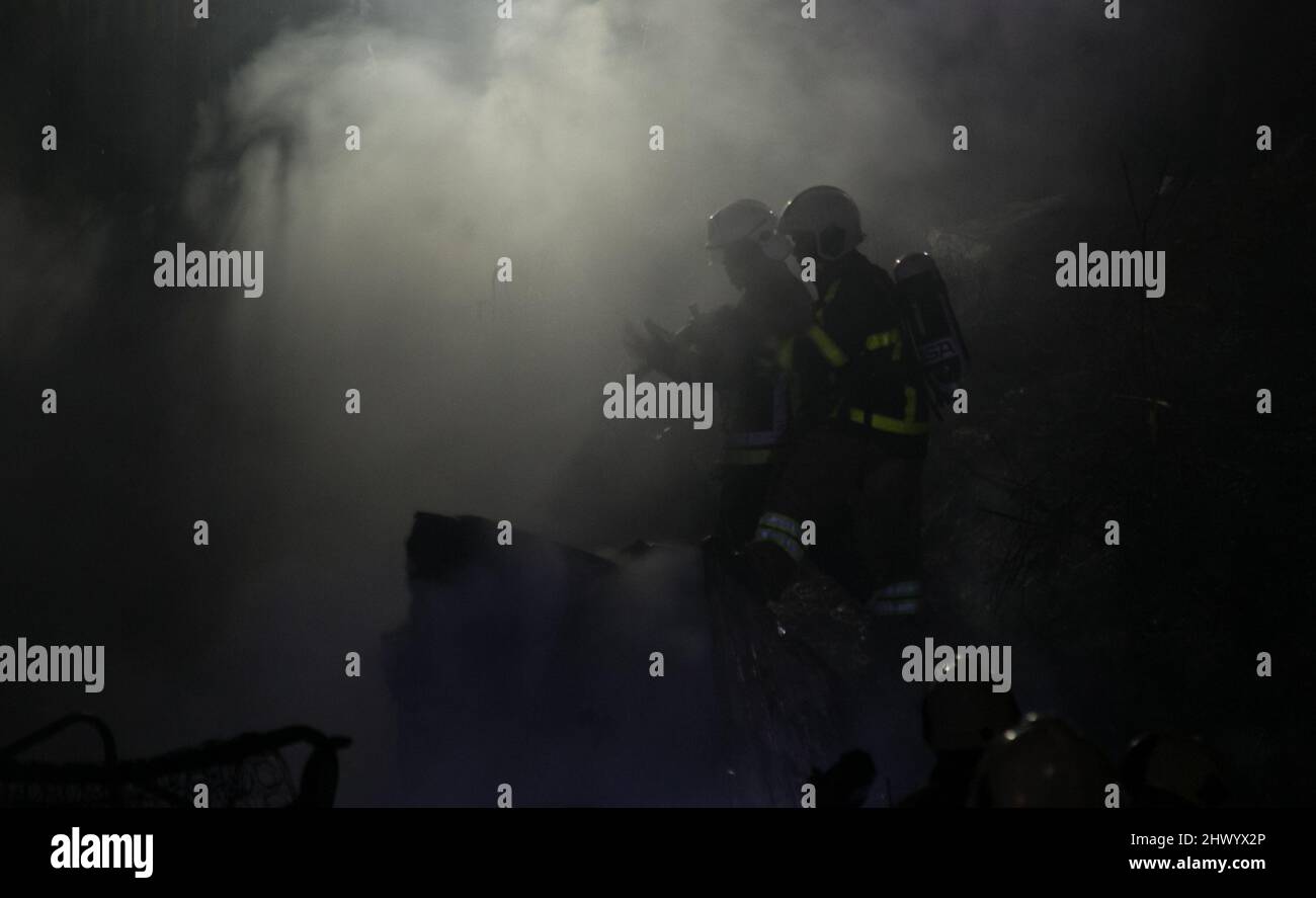 Kathmandu, Nepal. 8th Mar, 2022. Firefighters work to put out a fire at ...