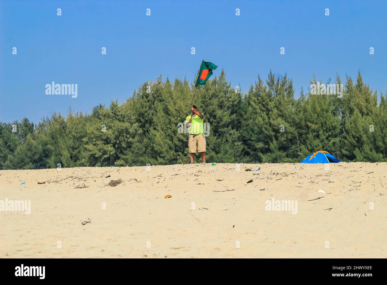 Bangladesh flag being waved by a man celebrating success. A beautiful ...