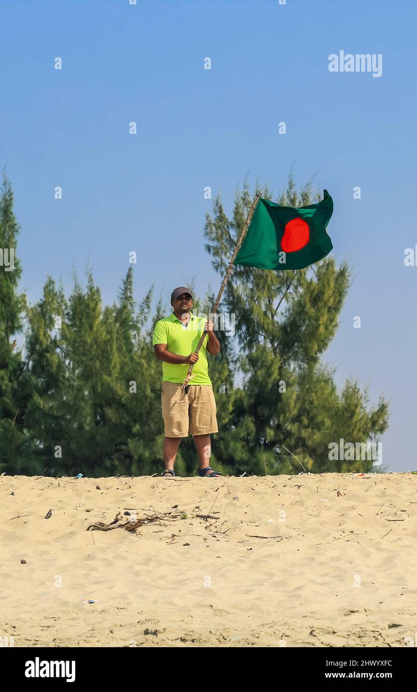Bangladesh flag being waved by a man celebrating success. A beautiful ...