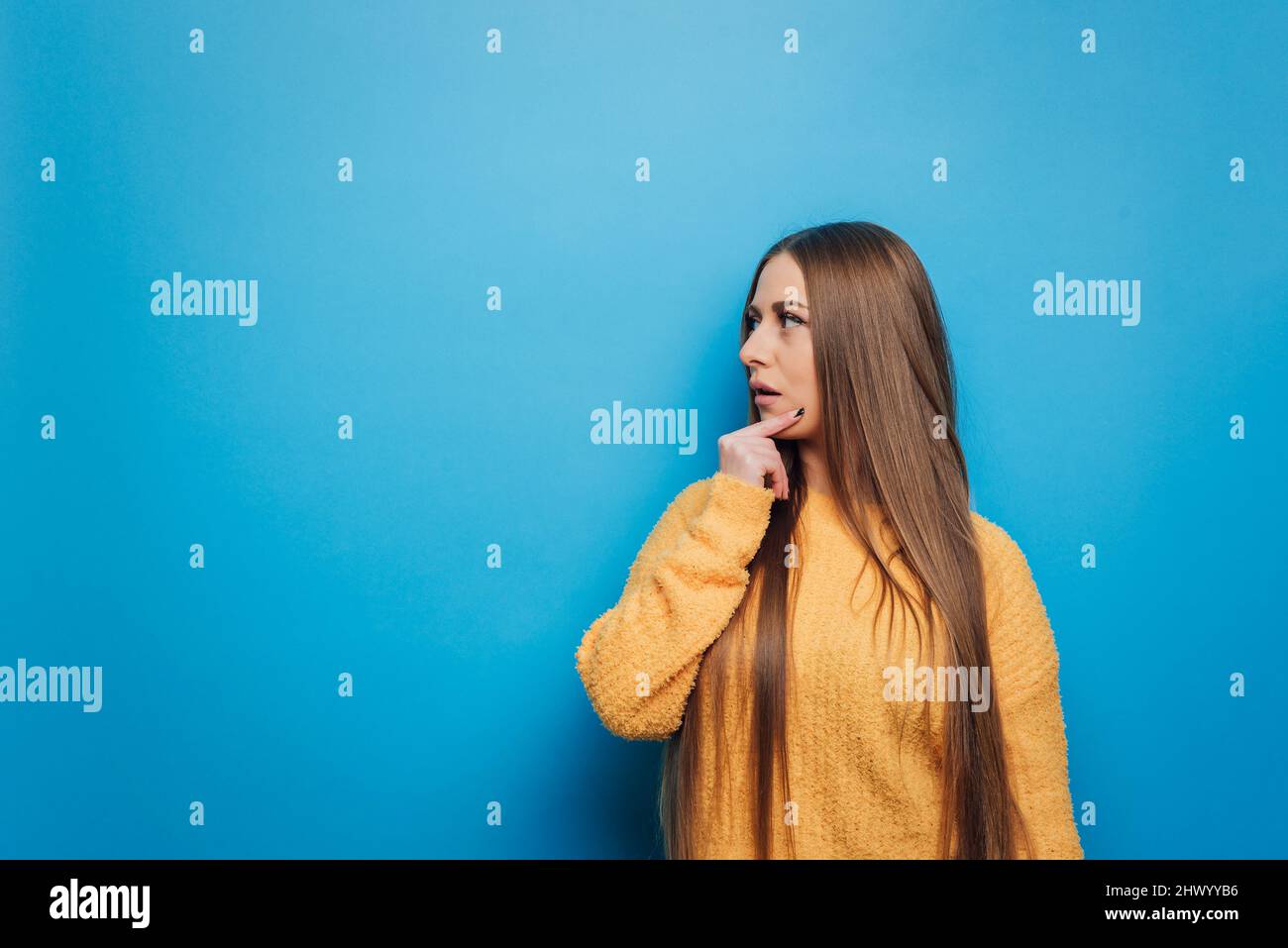 Woman looking to the side with shock and surprise expression while ...