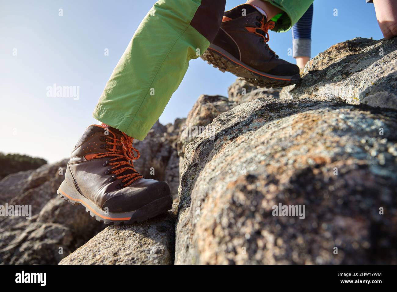 Unrecognizable boy clambering over rocks in the wilderness Stock Photo ...