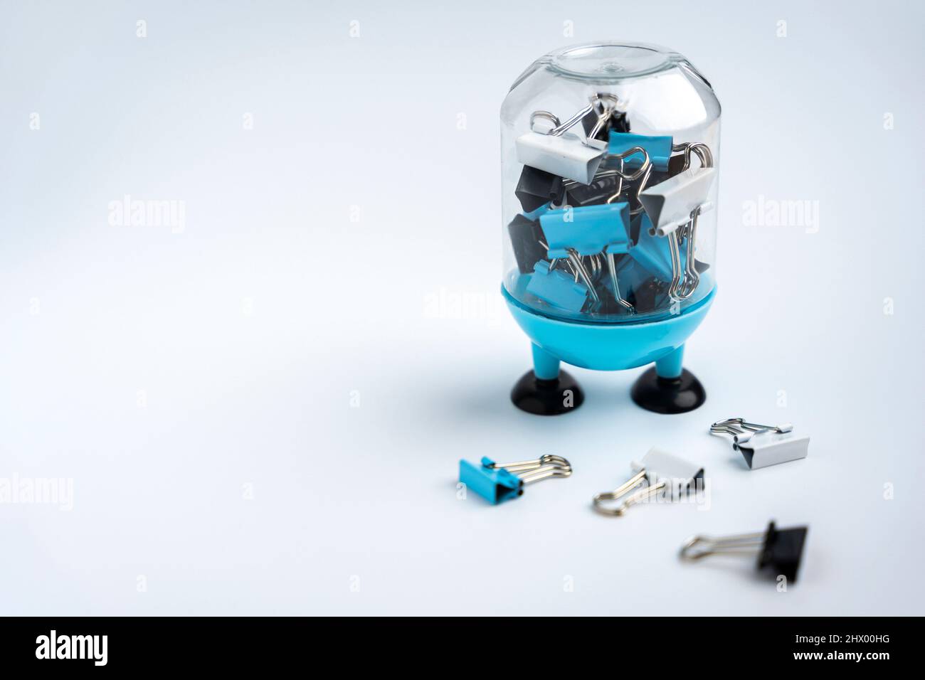 blue and white paper clips in a funny stylized case in the form of a ...