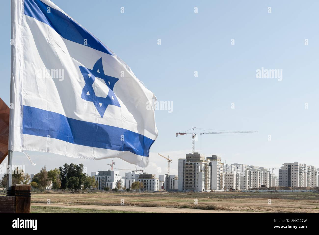 National Israeli flag, background Construction site. The beginning of ...