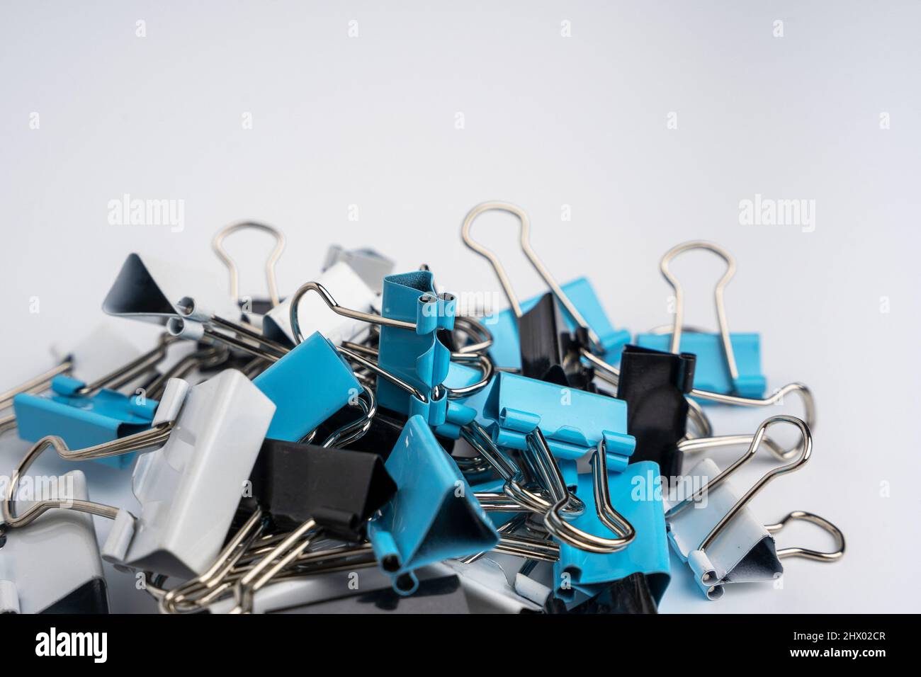 colored paper clips on a white background. Office supplies. copy space ...