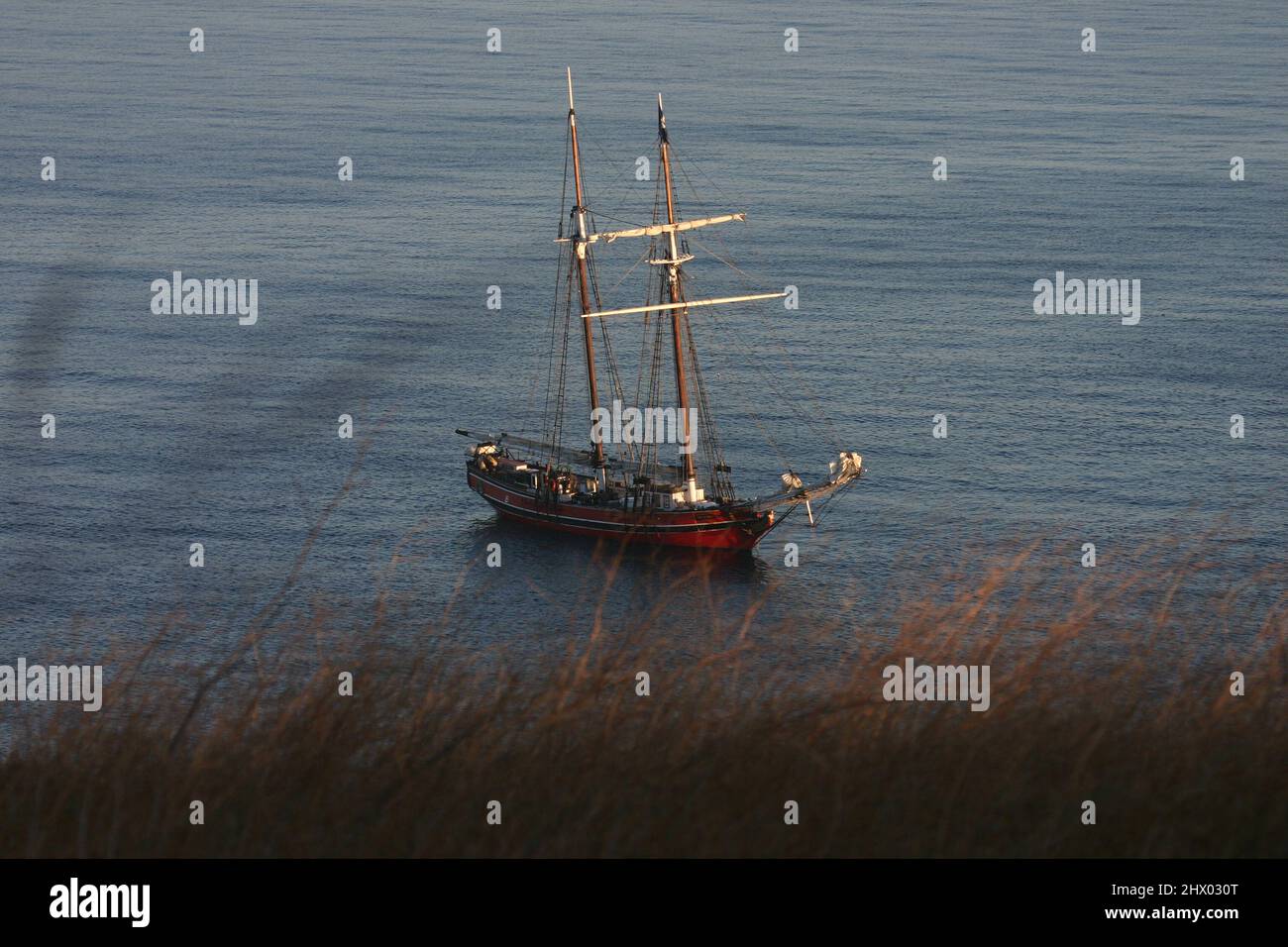 Red sailing ship off the coast of Catalina Island, California ; USA ...