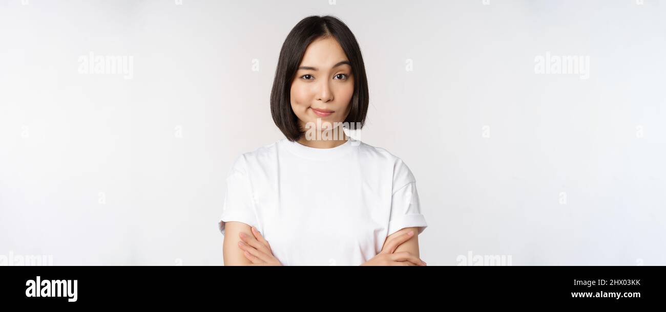 Close up of korean girl, looking skeptical, cross arms on chest and ...