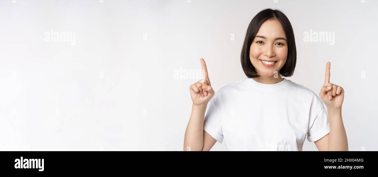 Portrait Of Enthusiastic Young Woman Asian Girl Smiling Pointing