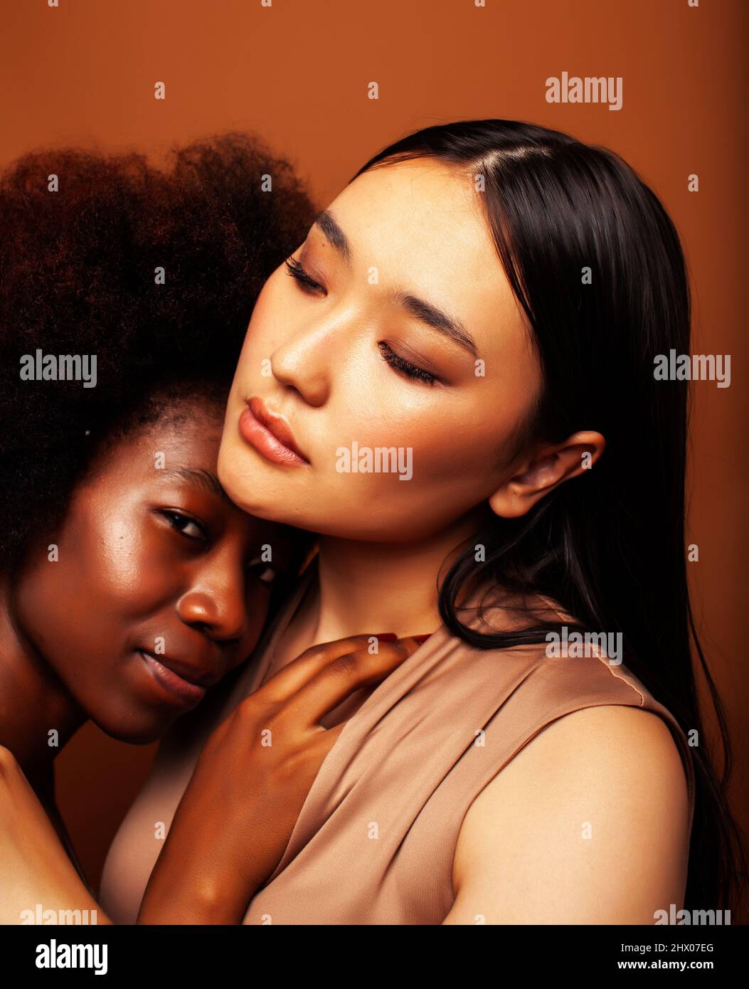 young pretty asian, african american woman posing cheerful together on ...