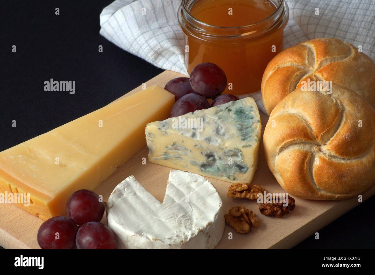 Cheese platter consisting of camembert cheese, blue cheese and parmesan ...