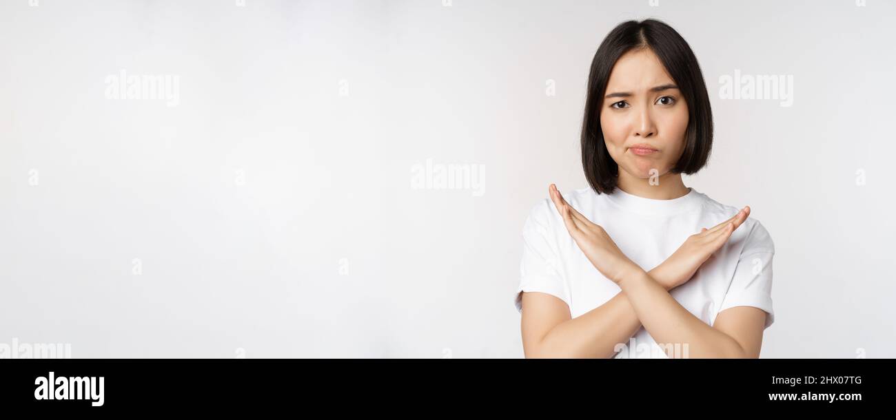 Portrait of asian korean woman showing stop, prohibition gesture ...