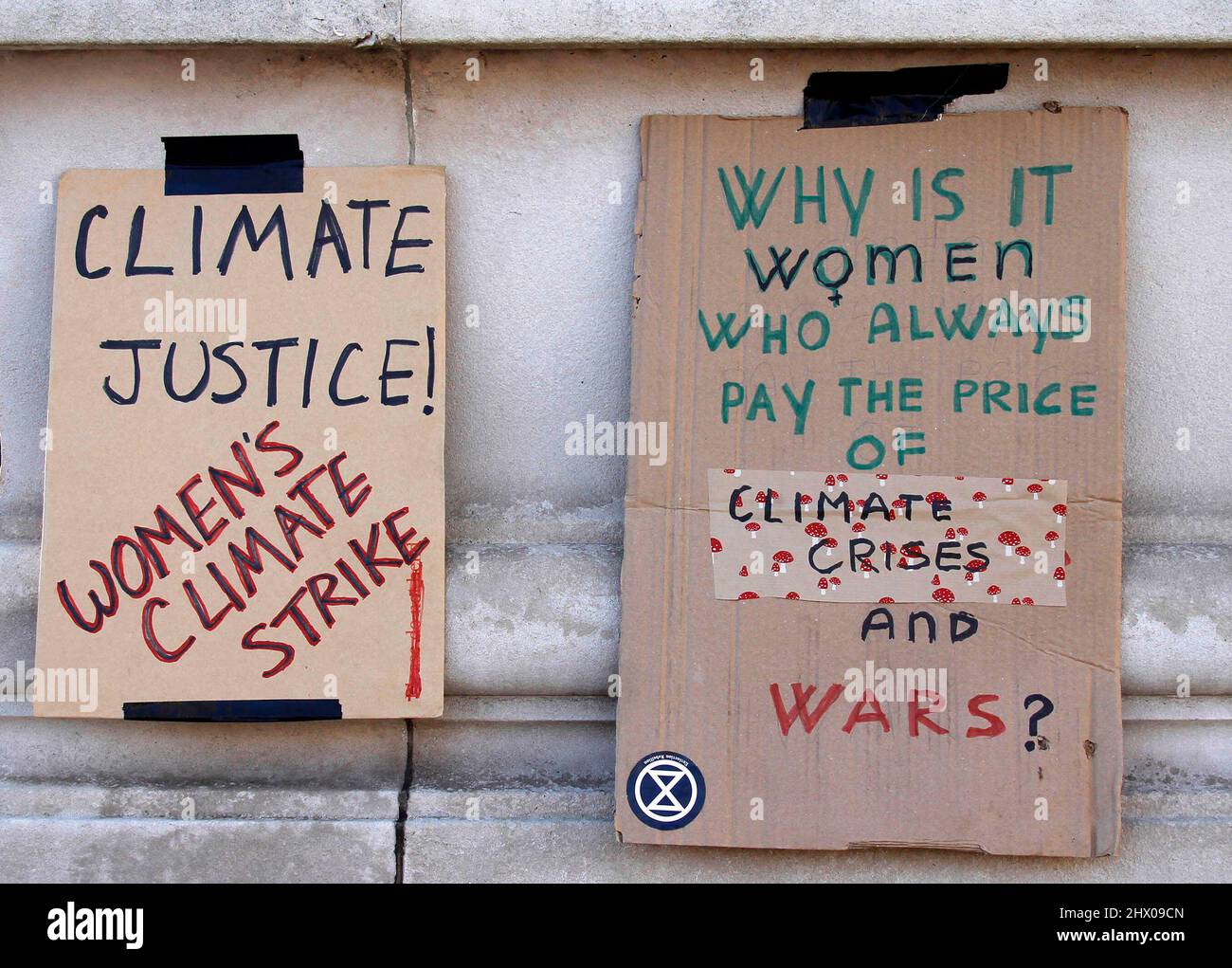 Signs rest against a wall as a group of female protesters use ...