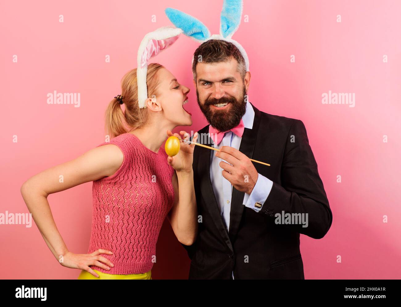 Happy Family celebrate Easter Day. Couple in bunny ears painting egg ...