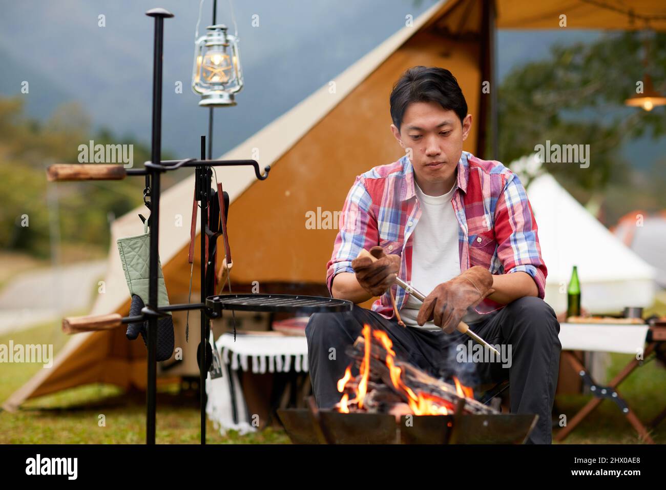 Japanese Man Making A Fire Stock Photo - Alamy