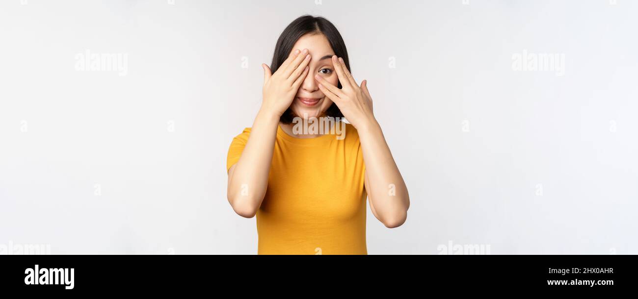 Cute korean female model, cover eyes with hands, peeking through ...