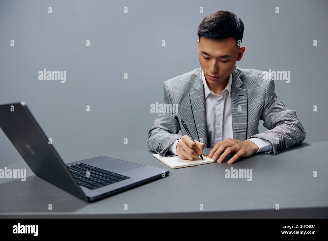 worker writing in a notebook laptop work at the desktop isolated ...