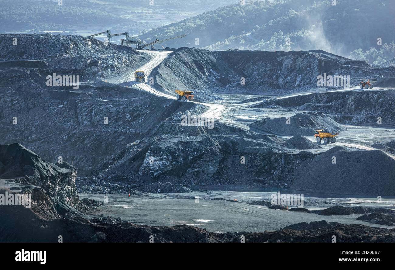 Mining trucks working at stone quarry, industrial landscape Stock Photo ...