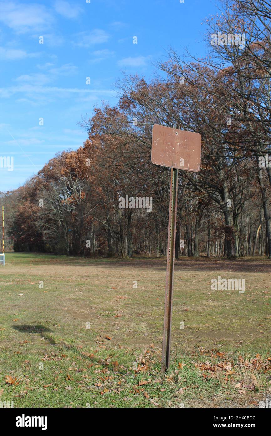 Field with illegible rusty sign Stock Photo - Alamy