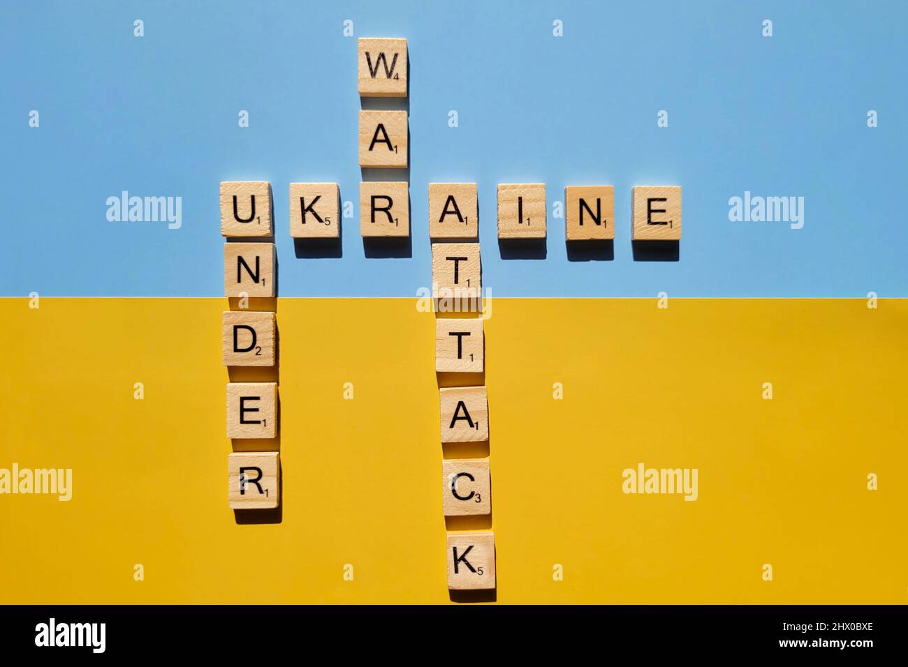 Words on wooden alphabet letters on yellow, blue background close up ...