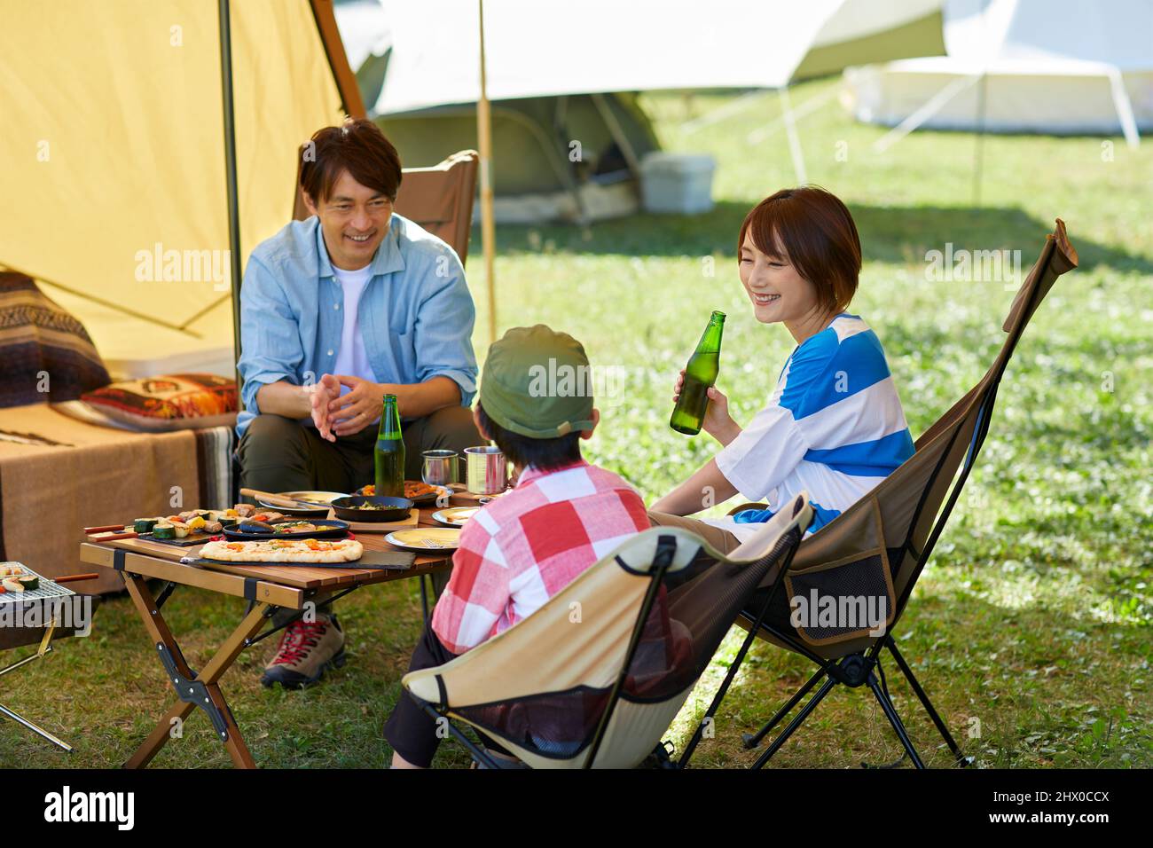Japanese Family Talking At Campsite Stock Photo - Alamy