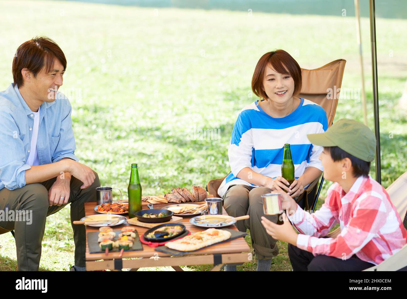 Japanese Family Talking At Campsite Stock Photo - Alamy
