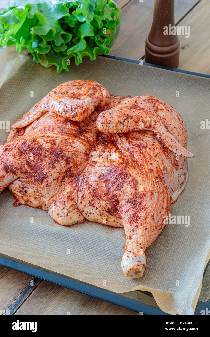Raw whole chicken on an oven tray. chicken tobacco Stock Photo - Alamy