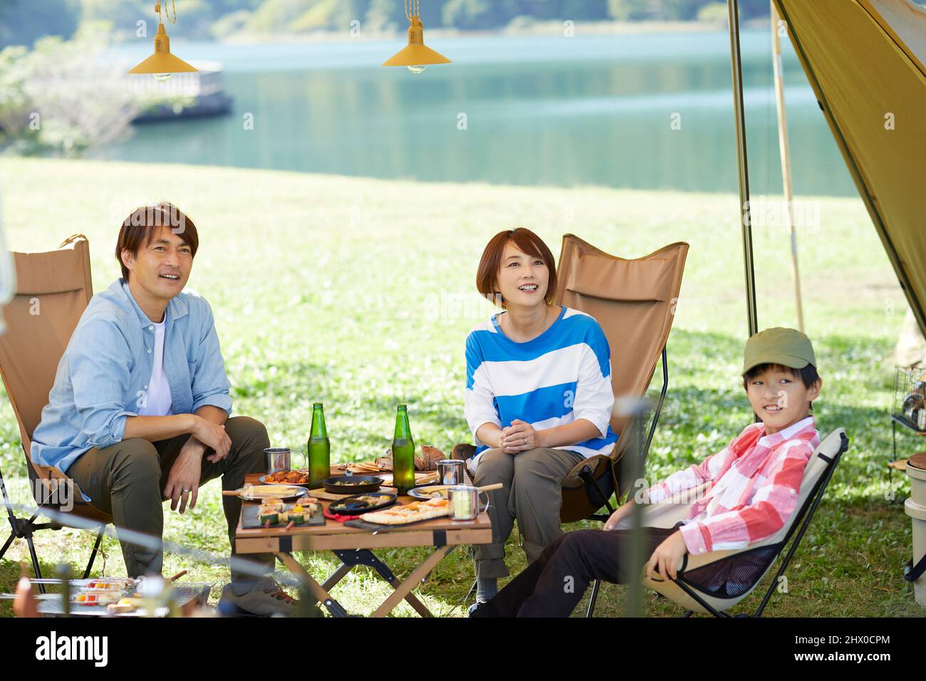 Japanese Family Talking At Campsite Stock Photo - Alamy