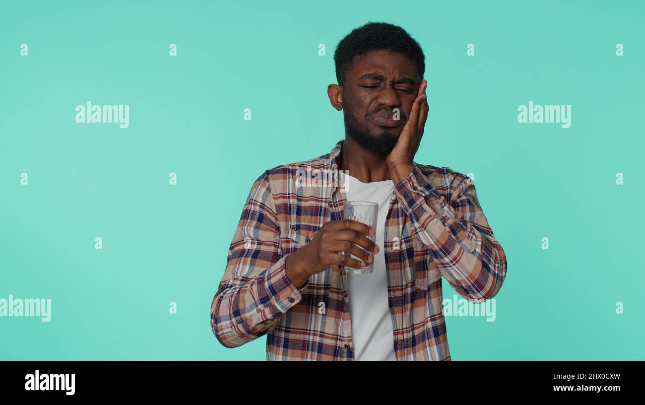 Man touching cheek suffering from toothache cavities or gingivitis ...