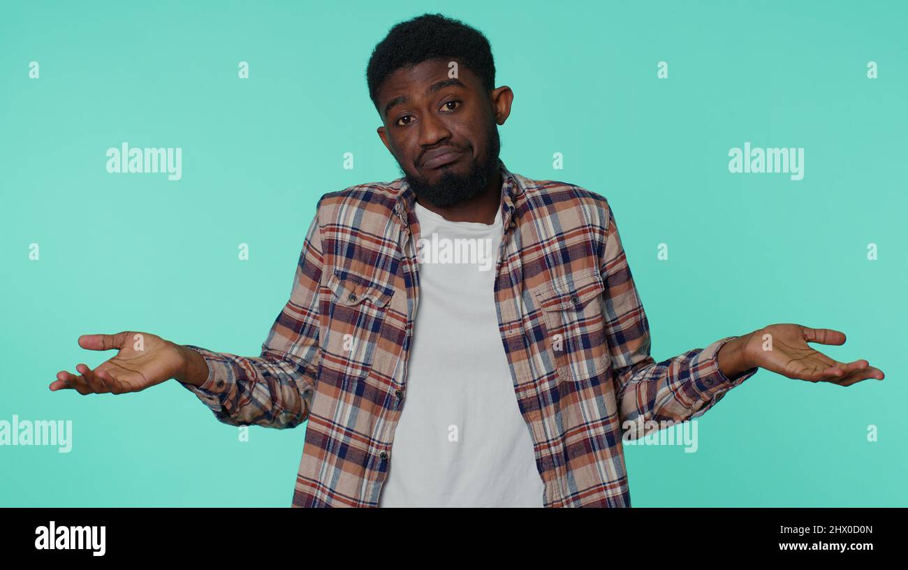 Clueless african american man raising hands in helpless gesture ...