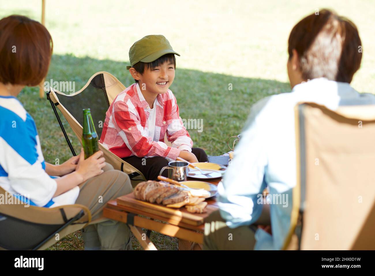 Japanese Family Talking At Campsite Stock Photo - Alamy