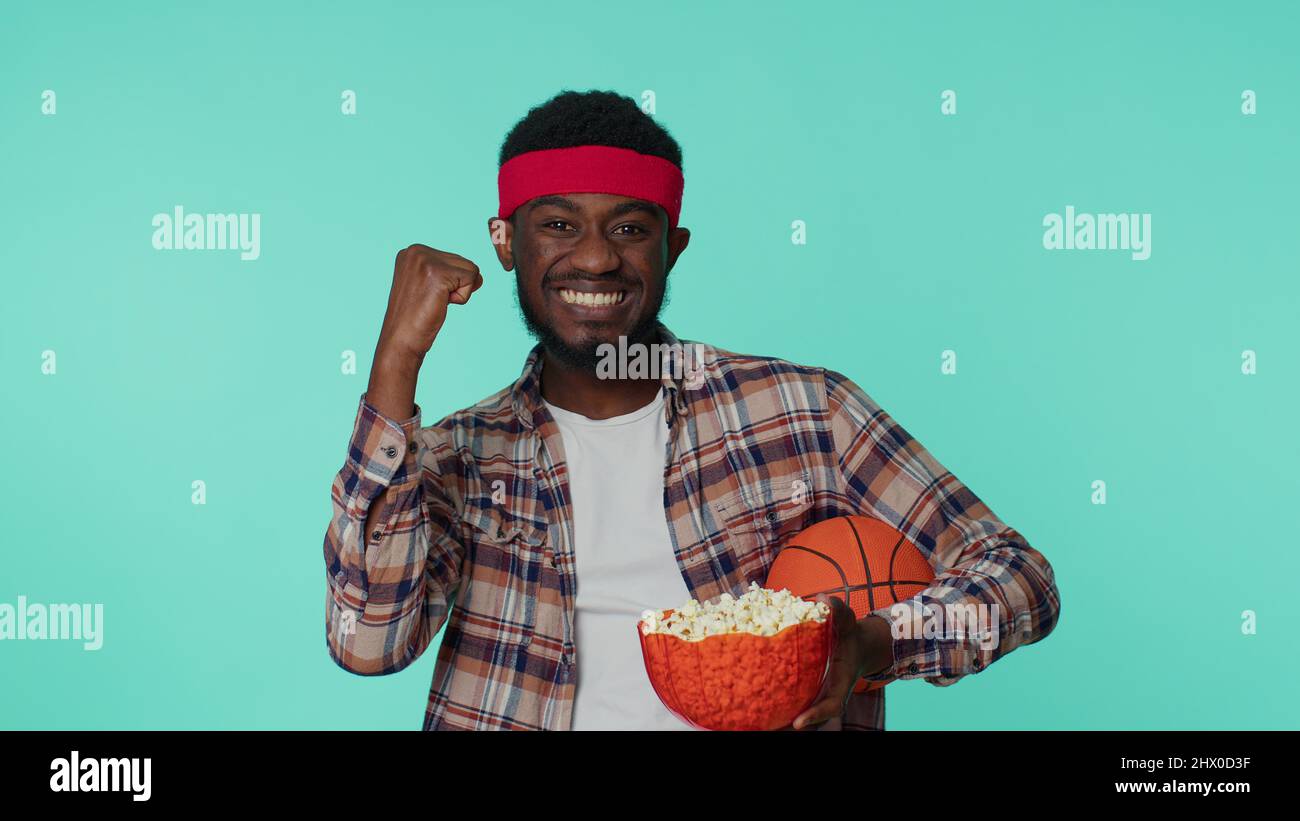 Bearded african american young man basketball fan holding ball doing ...