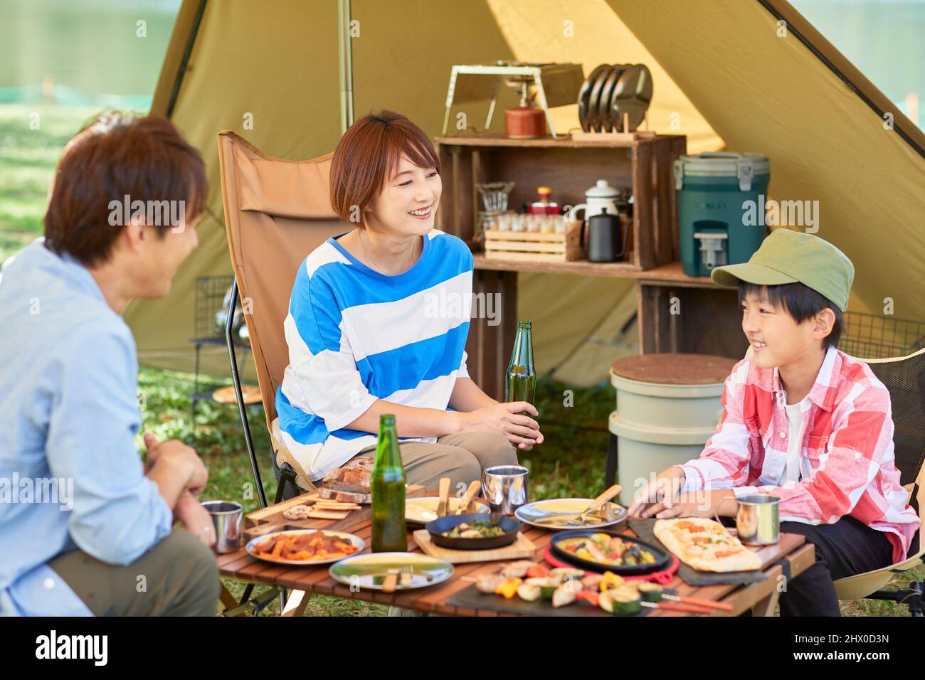 Japanese Family Talking At Campsite Stock Photo - Alamy