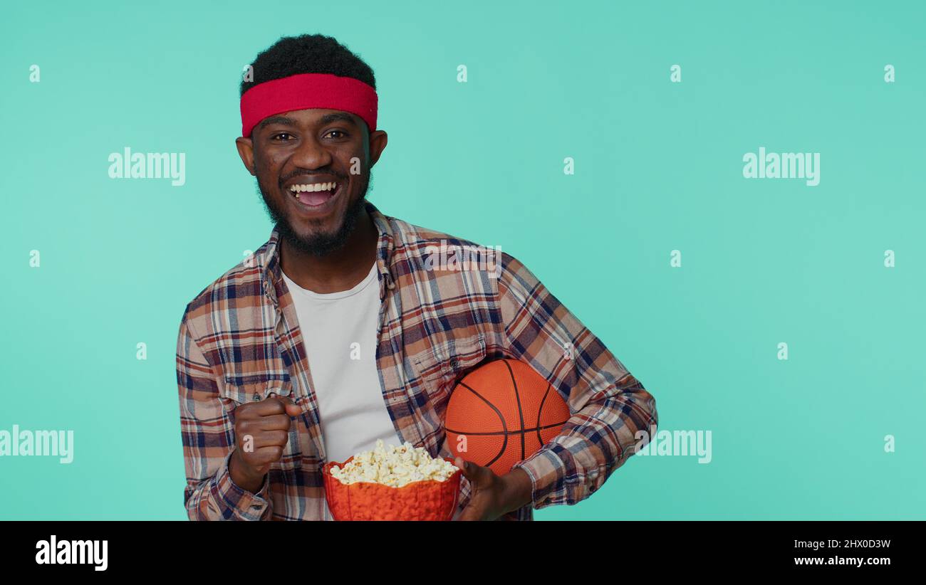 Bearded african american young man basketball fan holding ball doing ...