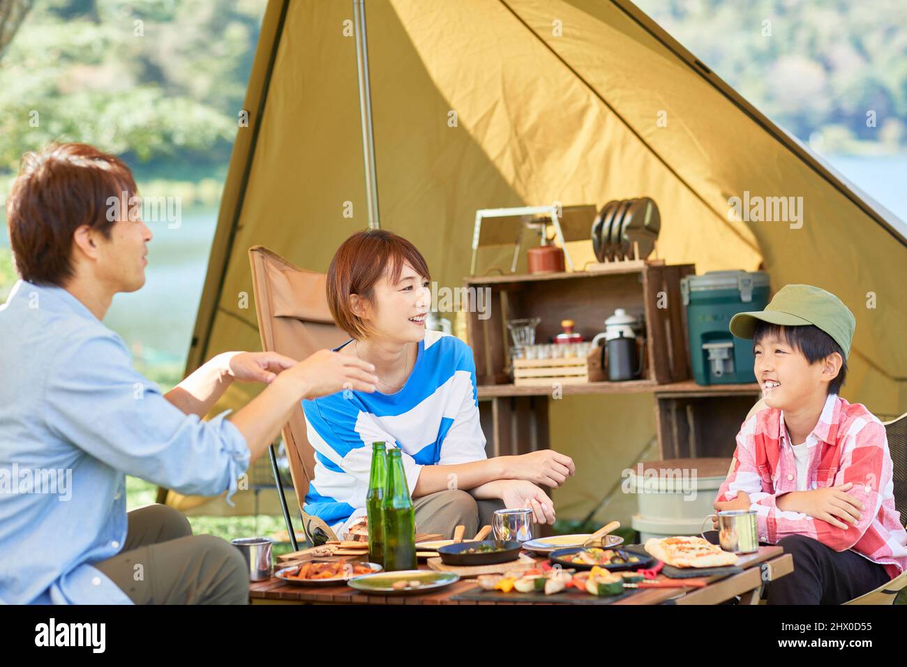 Japanese Family Talking At Campsite Stock Photo - Alamy