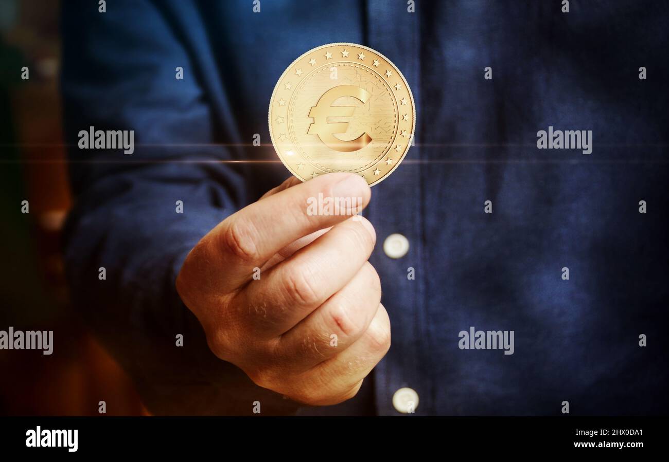 Euro EUR currency in EU symbol golden coin in hand abstract concept ...