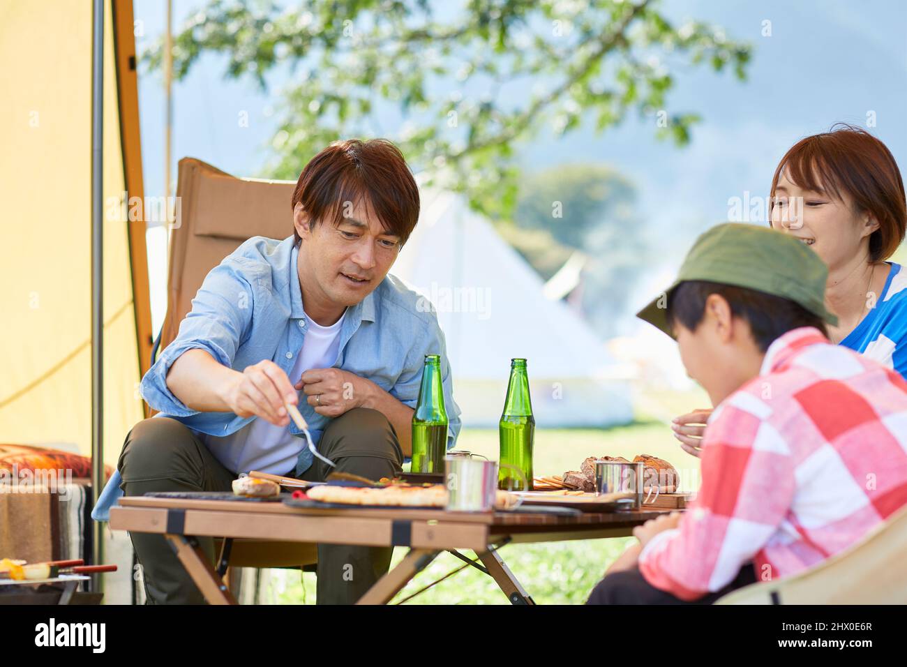 Japanese Family Talking At Campsite Stock Photo - Alamy