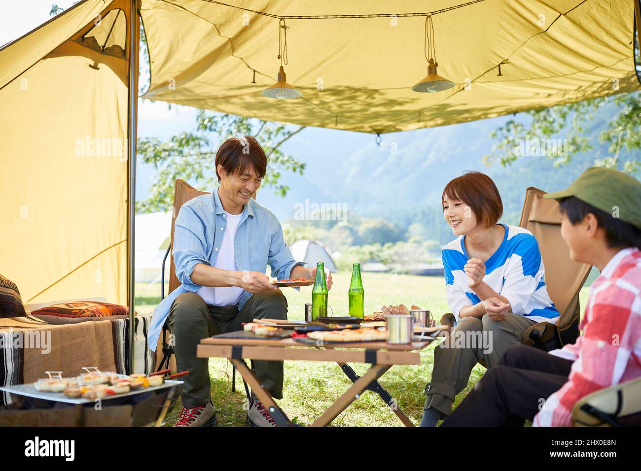 Japanese Family Talking At Campsite Stock Photo - Alamy