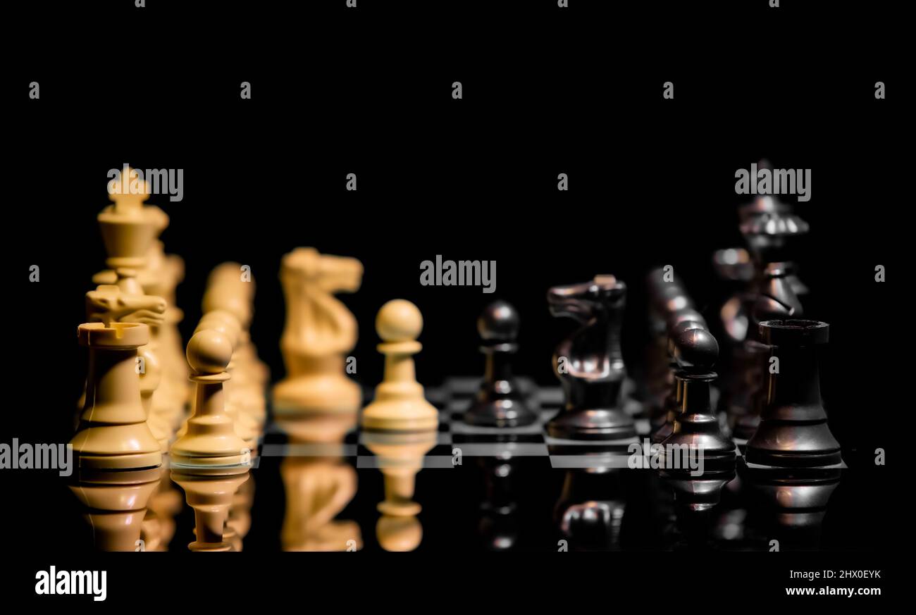 Close up of Chess pieces on a reflective mirror board surface with a ...