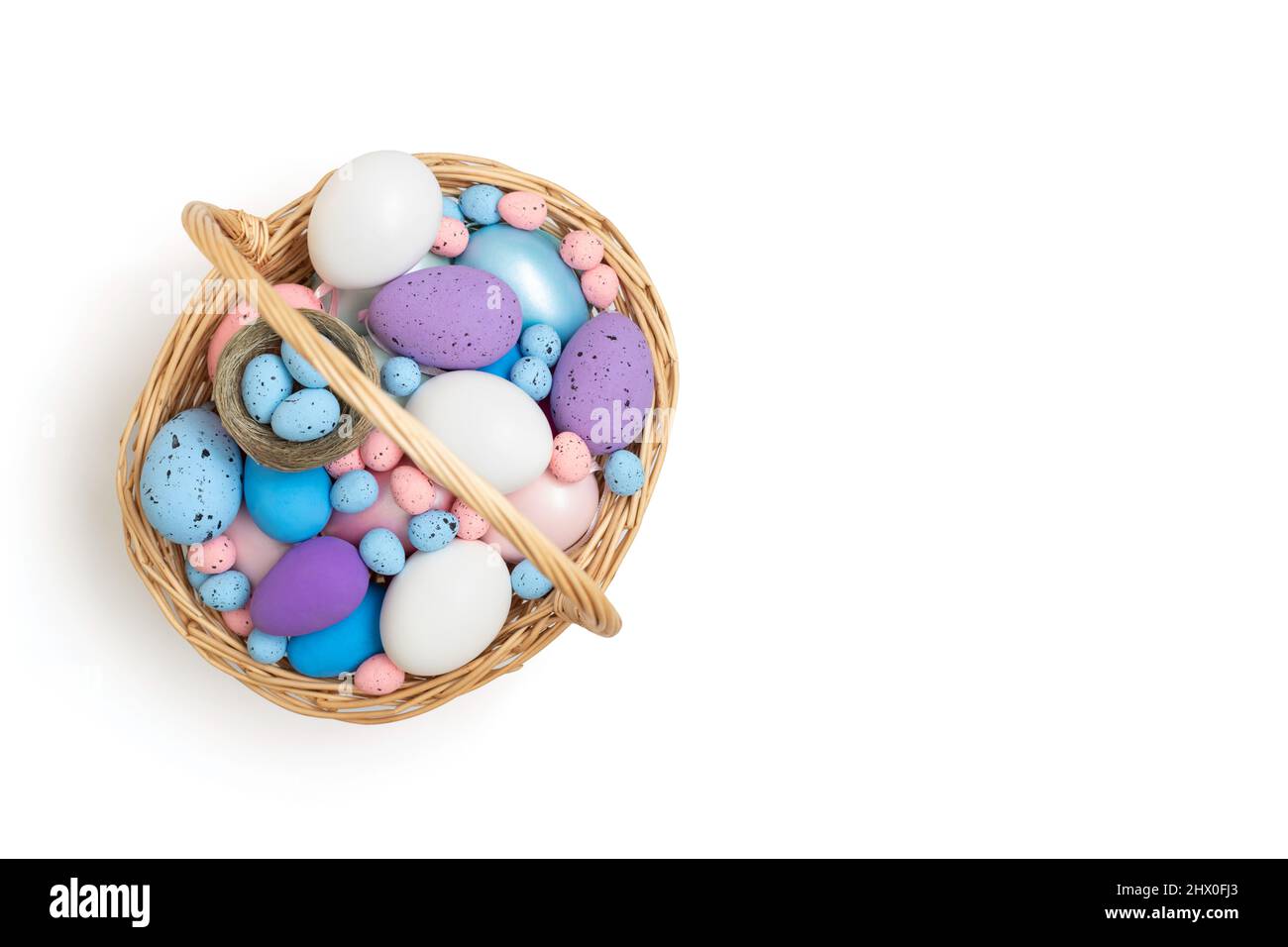 Easter eggs in a basket isolated on a white background. Festive decor ...