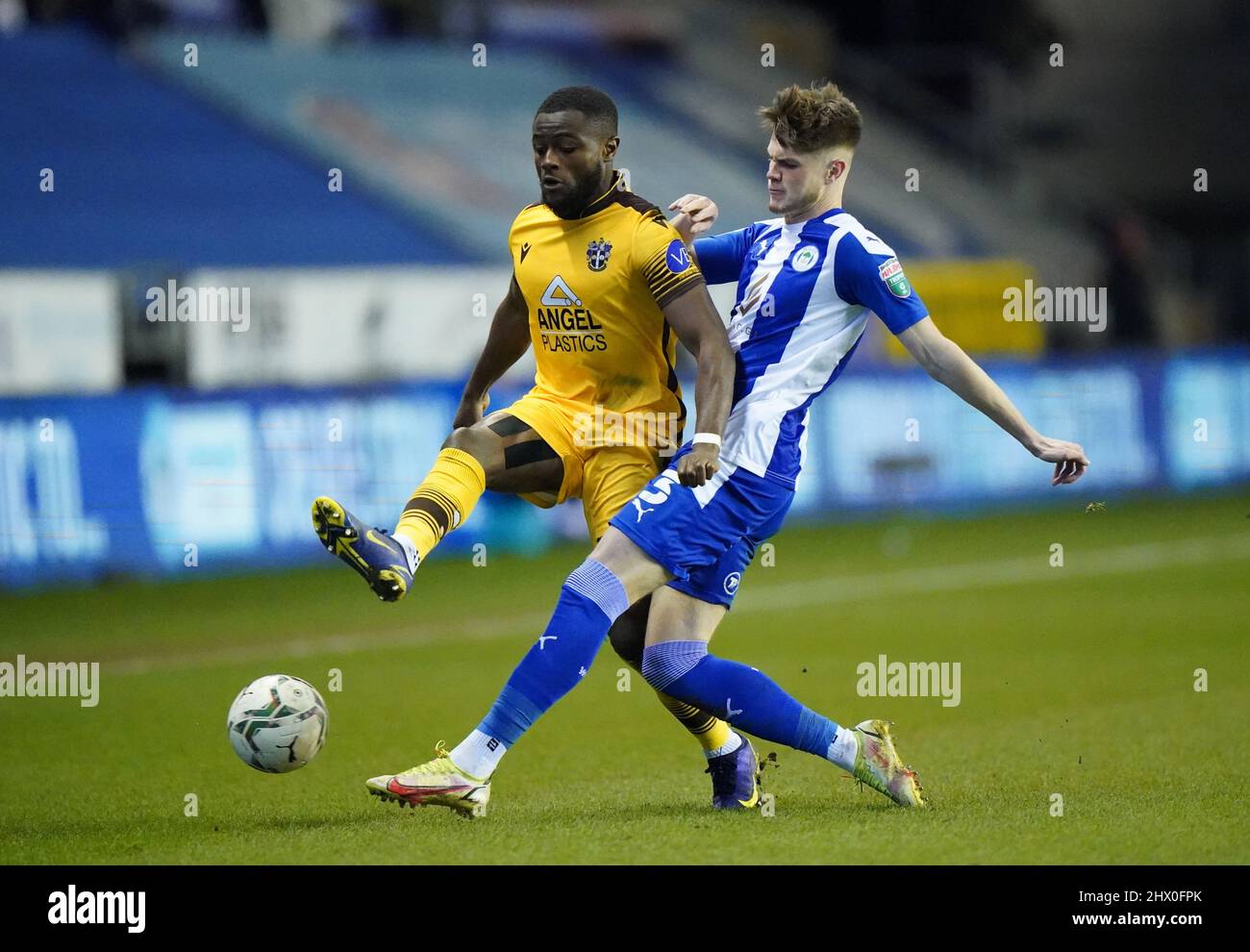 Wigan Athletic's Tom Pearce (right) and Sutton United's David Ajiboye ...