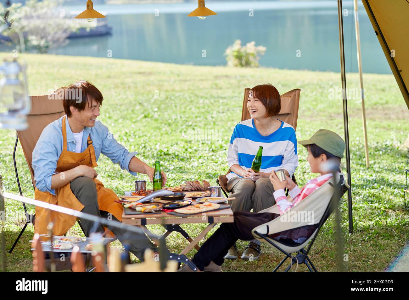 Japanese Family Talking At Campsite Stock Photo - Alamy