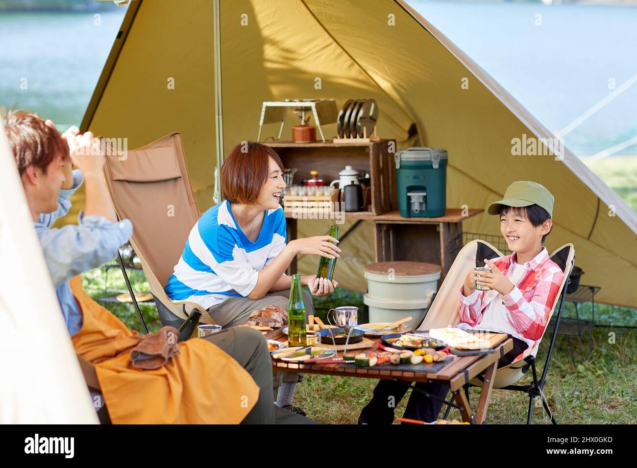 Japanese Family Talking At Campsite Stock Photo - Alamy
