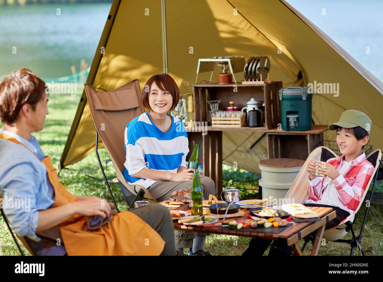 Japanese Family Talking At Campsite Stock Photo - Alamy