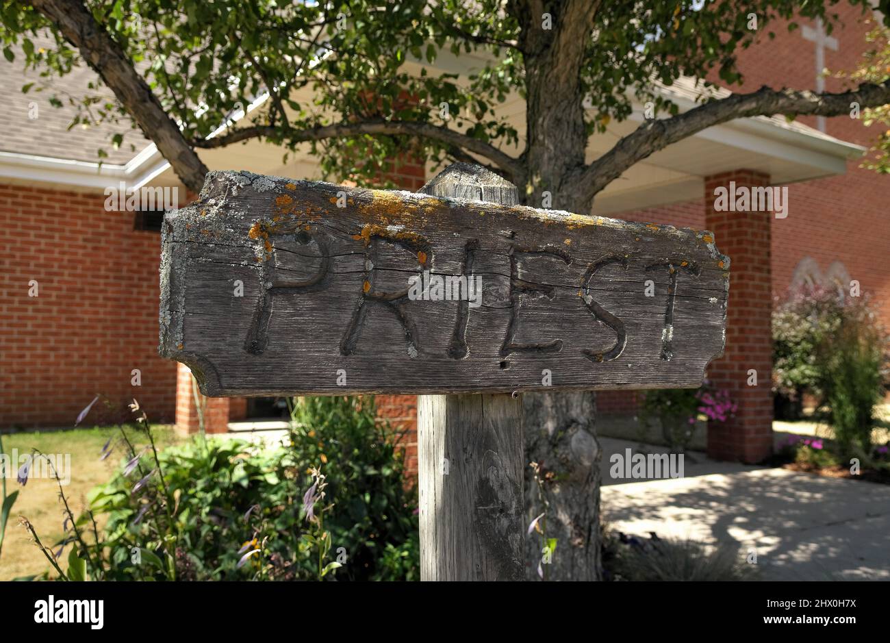 Rustic Parking Sign for Priest in Front of Modern Christian Church ...