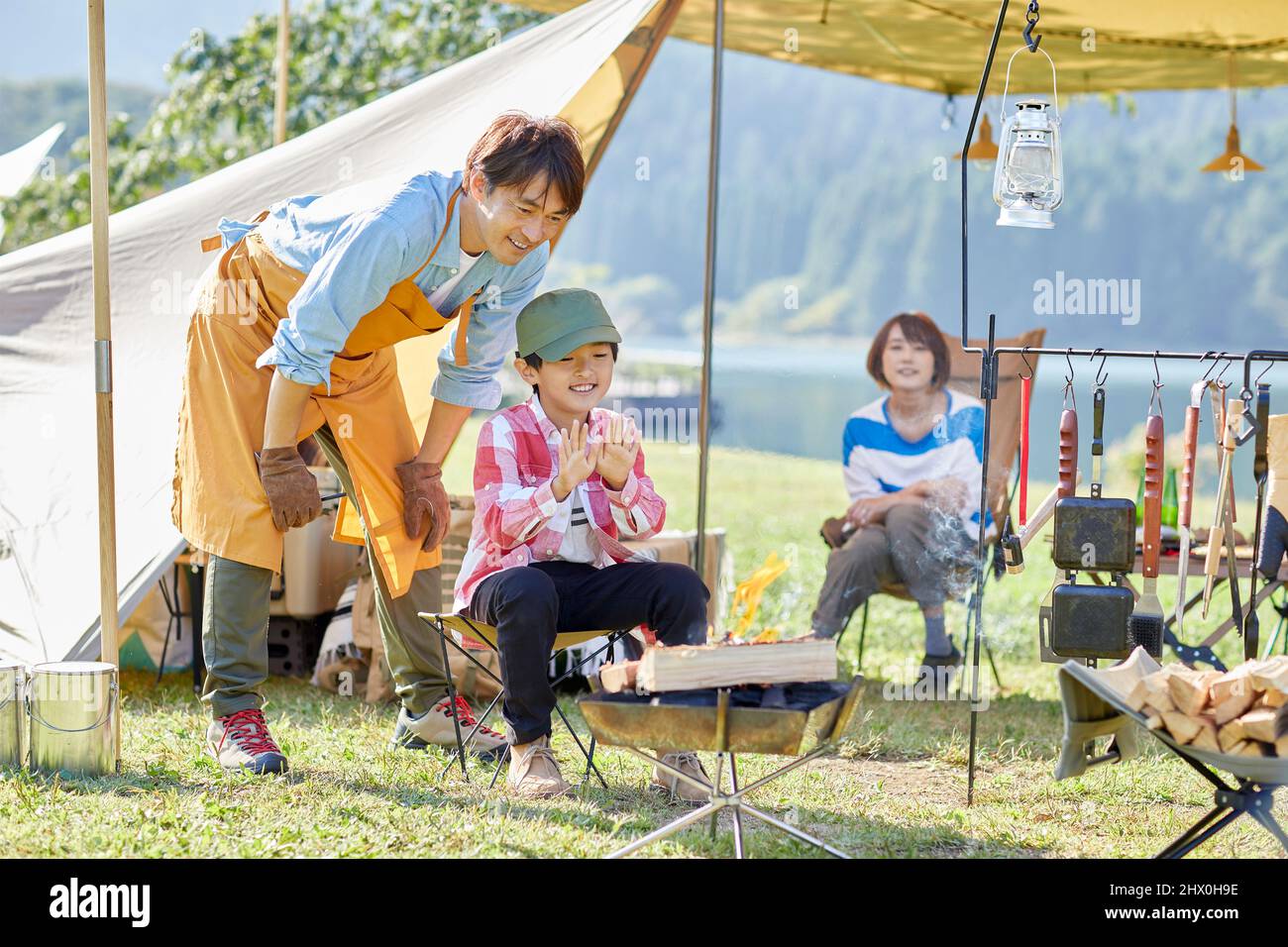 Japanese Parent And Child Making A Fire Stock Photo - Alamy