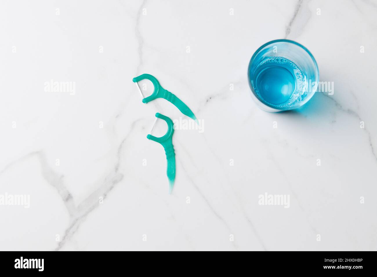 Mouthwash and floss picks on marble background Stock Photo - Alamy