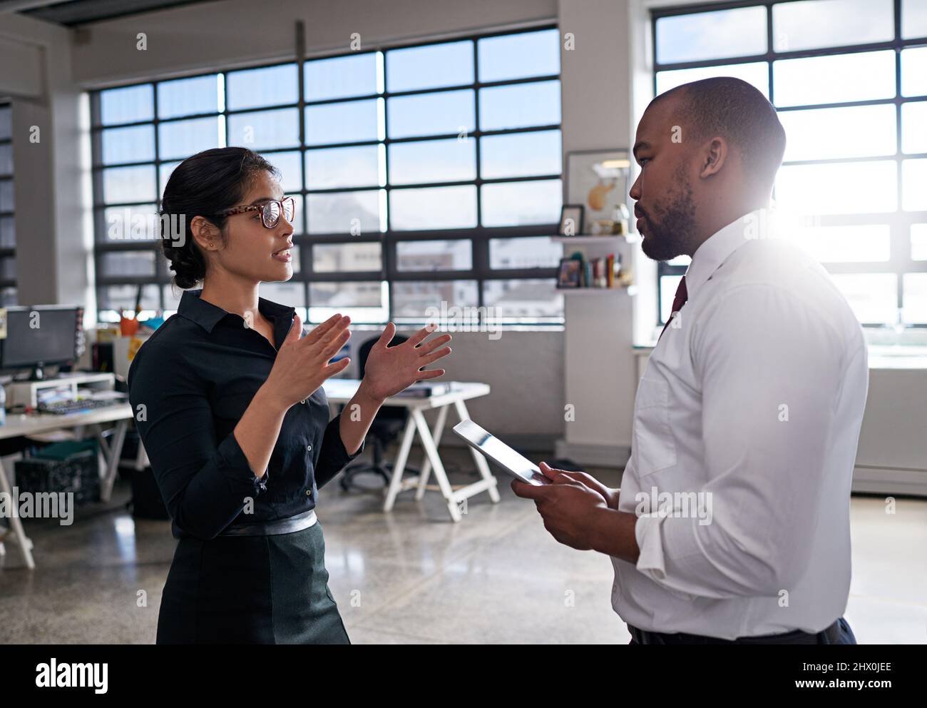 Throwing around a few ideas. Shot of colleagues having a discussion at ...